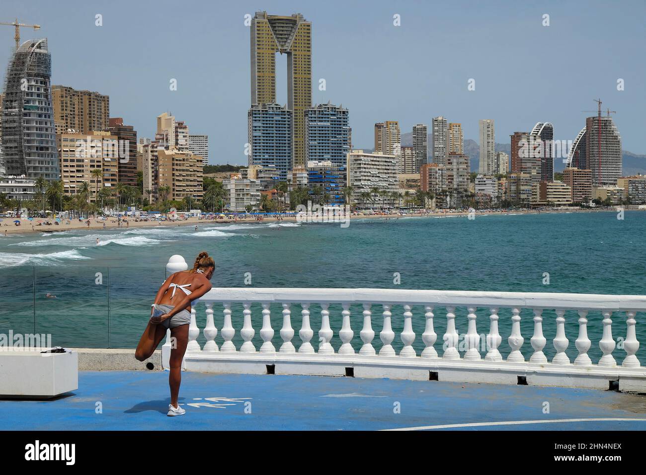 Woman exercise in front of the skyline of Benidorm Stock Photo - Alamy