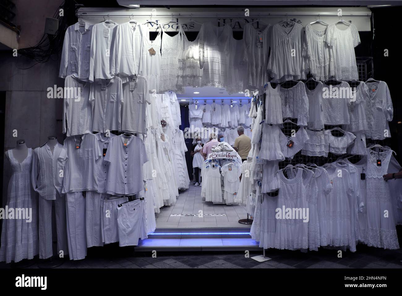 White clothes in a store of the old town of Benidorm Stock Photo - Alamy
