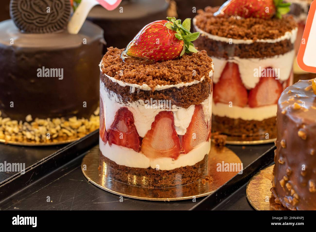 Fruity cake. Small cakes on display at the patisserie counter Stock ...