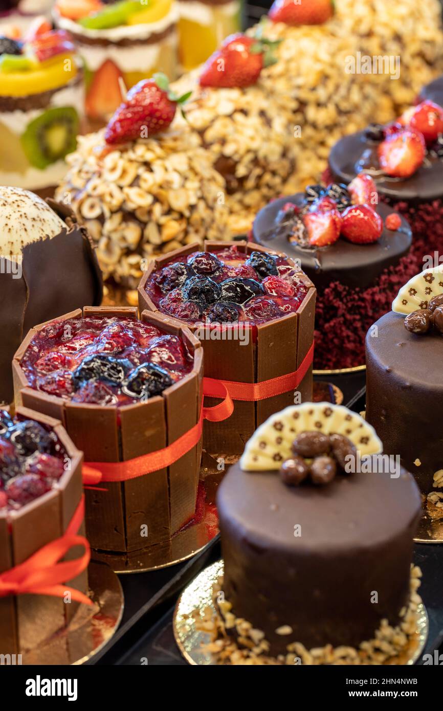 Small cakes on display at the patisserie counter Stock Photo - Alamy