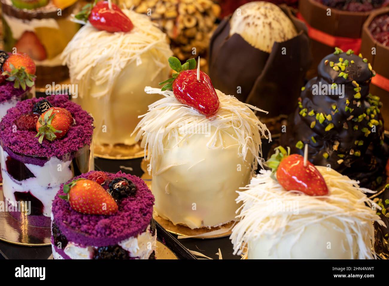 Small cakes on display at the patisserie counter Stock Photo - Alamy