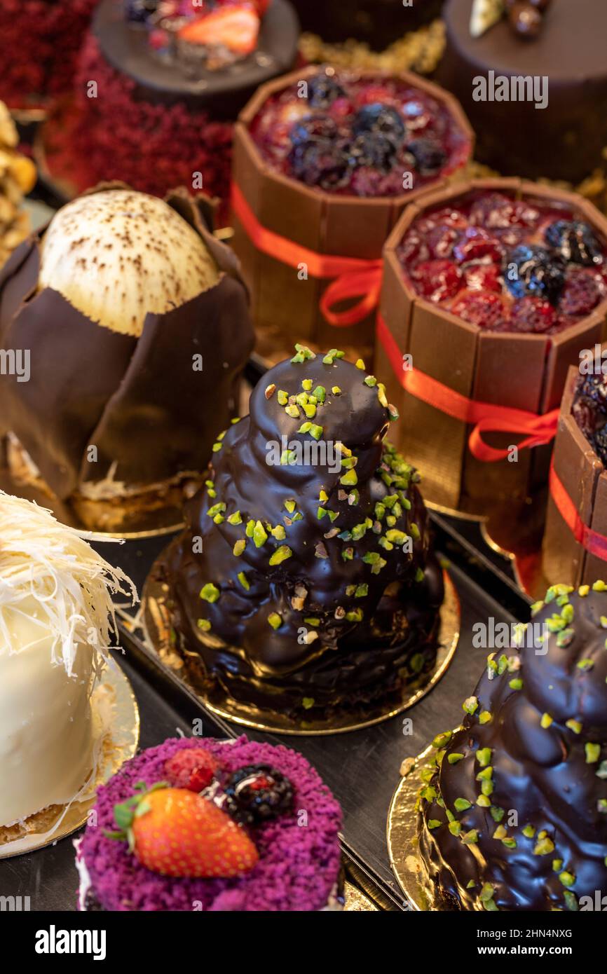 Small cakes on display at the patisserie counter Stock Photo - Alamy