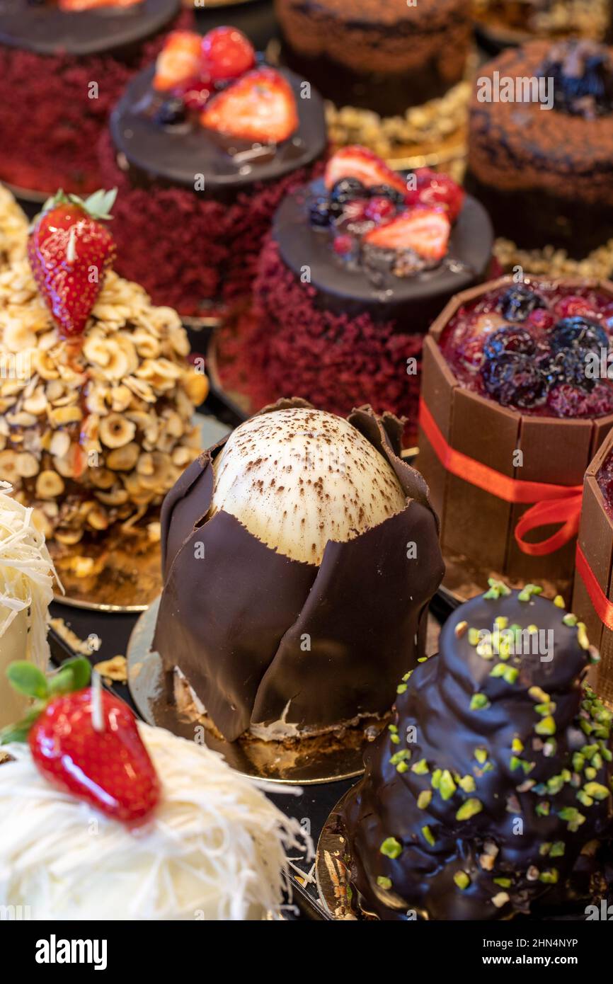 Small cakes on display at the patisserie counter Stock Photo - Alamy