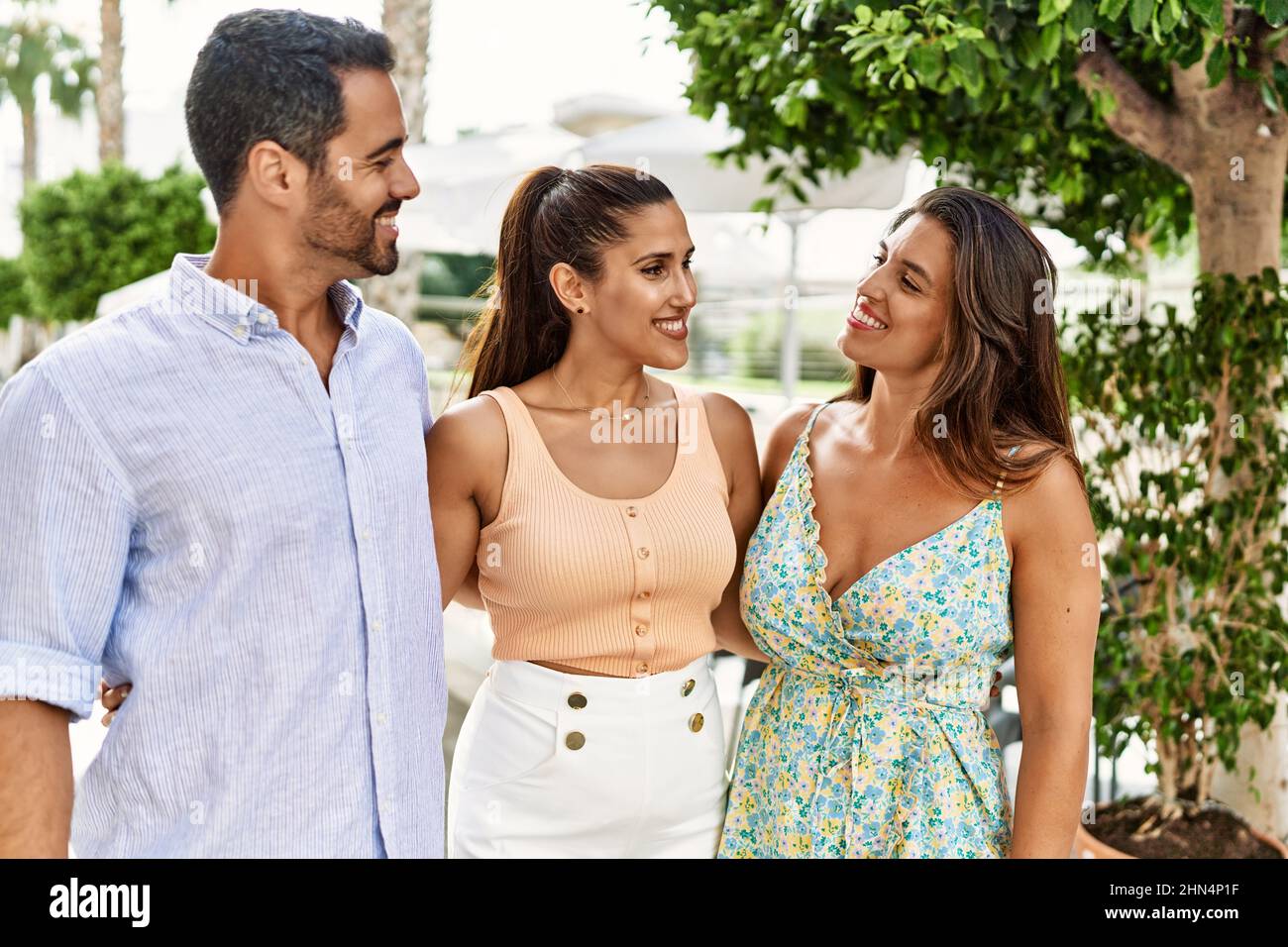 Three hispanic friends smiling happy and hugging at the city Stock ...