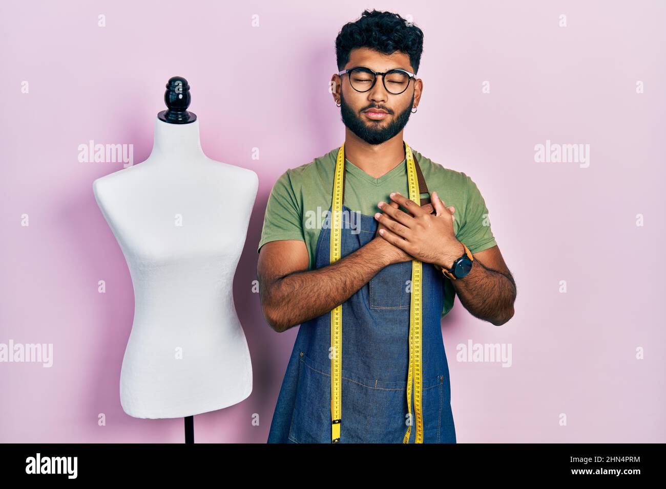Arab man with beard dressmaker designer wearing atelier apron smiling ...