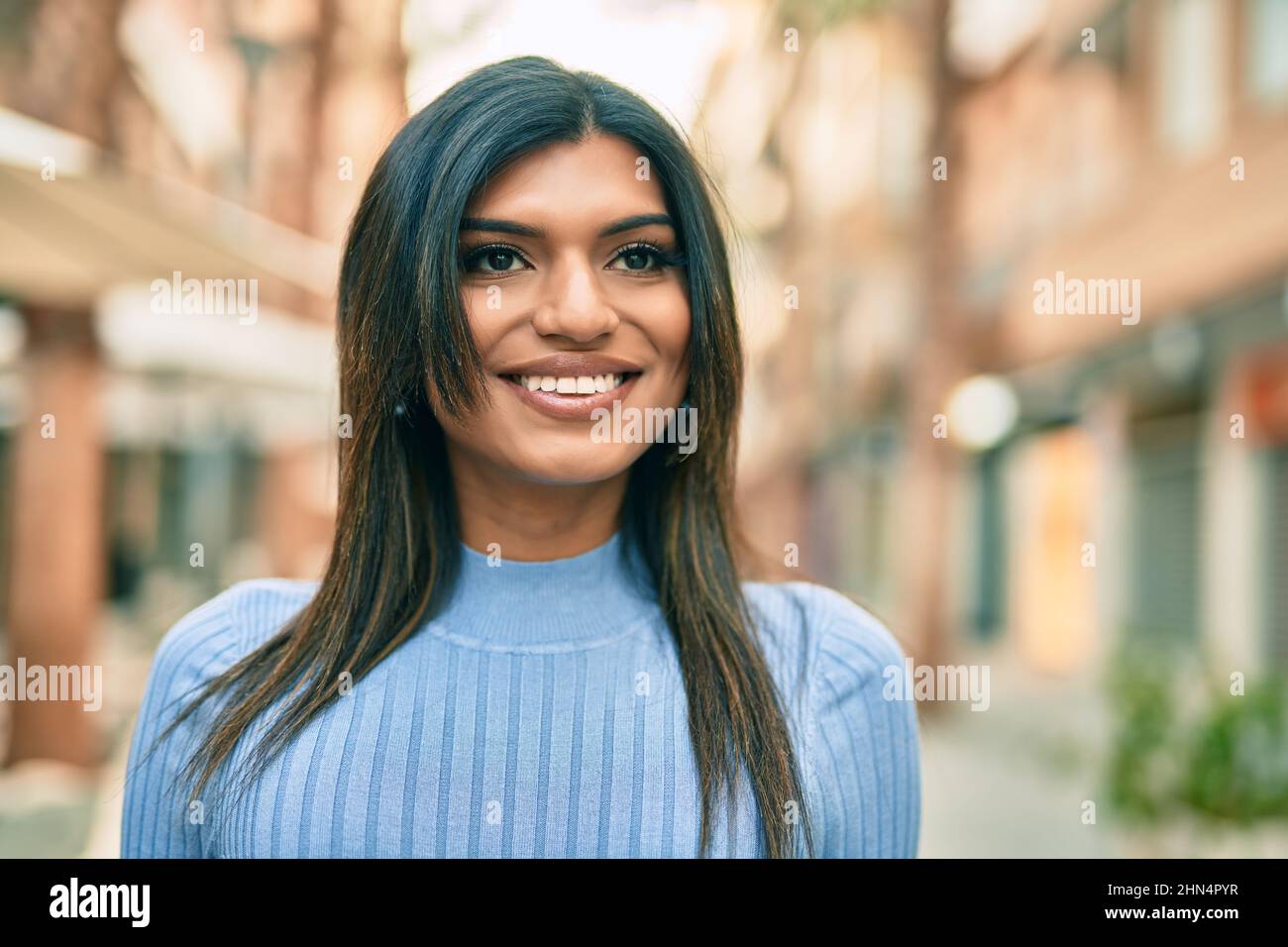 Beautiful hispanic woman smiling confient at the city Stock Photo - Alamy