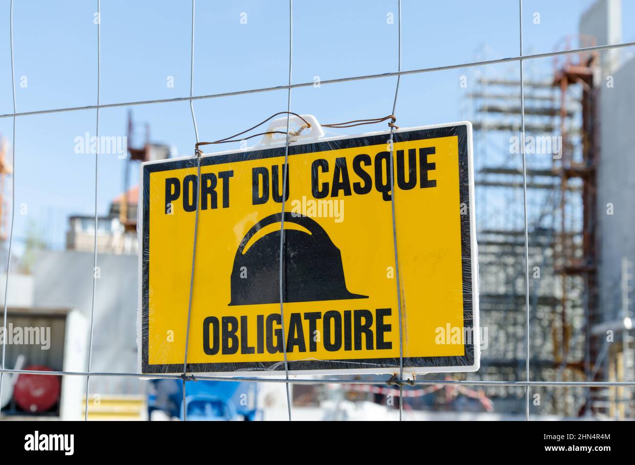 Mandatory helmet sign on construction site Stock Photo - Alamy