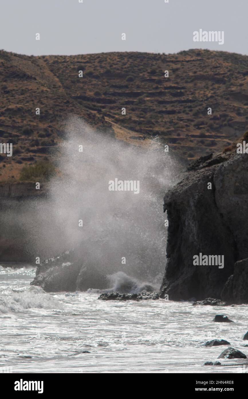 Big waves crushing on rocks at the famous red beach in Santorini Greece ...