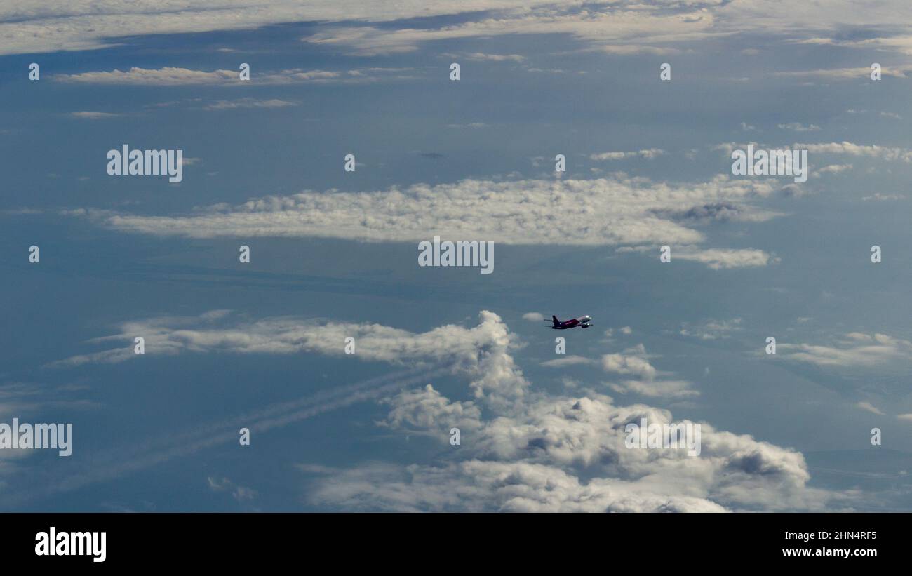 Flying airplane over clouds Stock Photo - Alamy