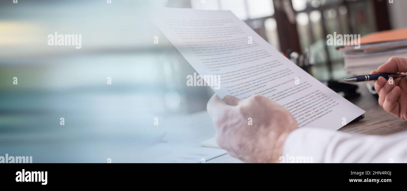 Checking a document in office; panoramic banner Stock Photo - Alamy