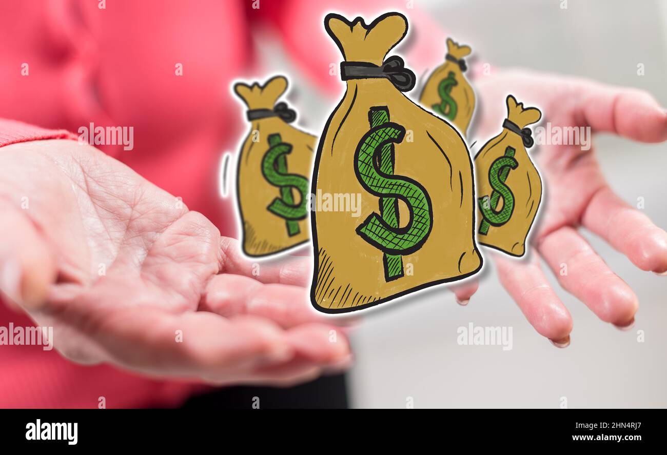 Money concept above the hands of a woman in background Stock Photo - Alamy