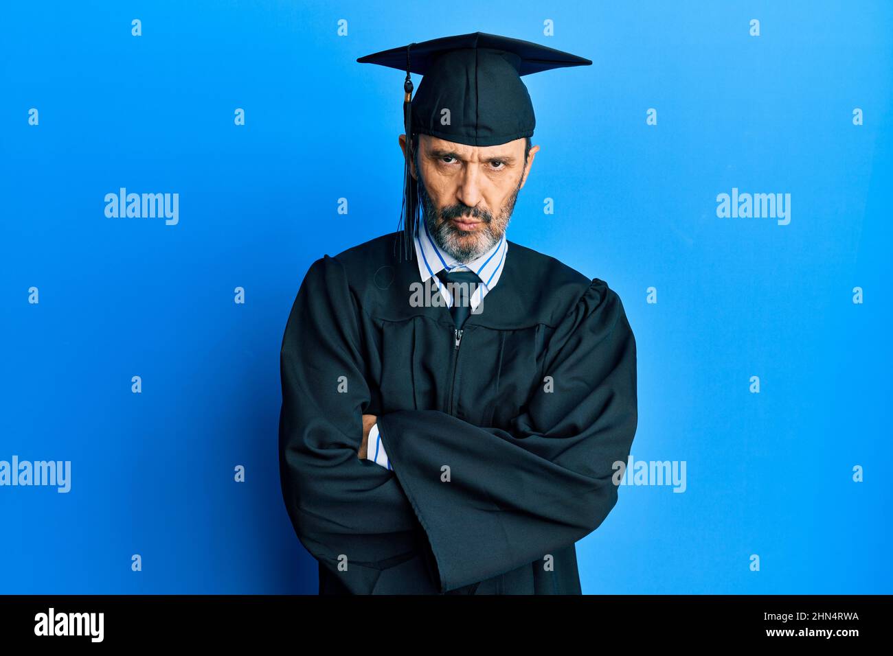 Middle age hispanic man wearing graduation cap and ceremony robe ...