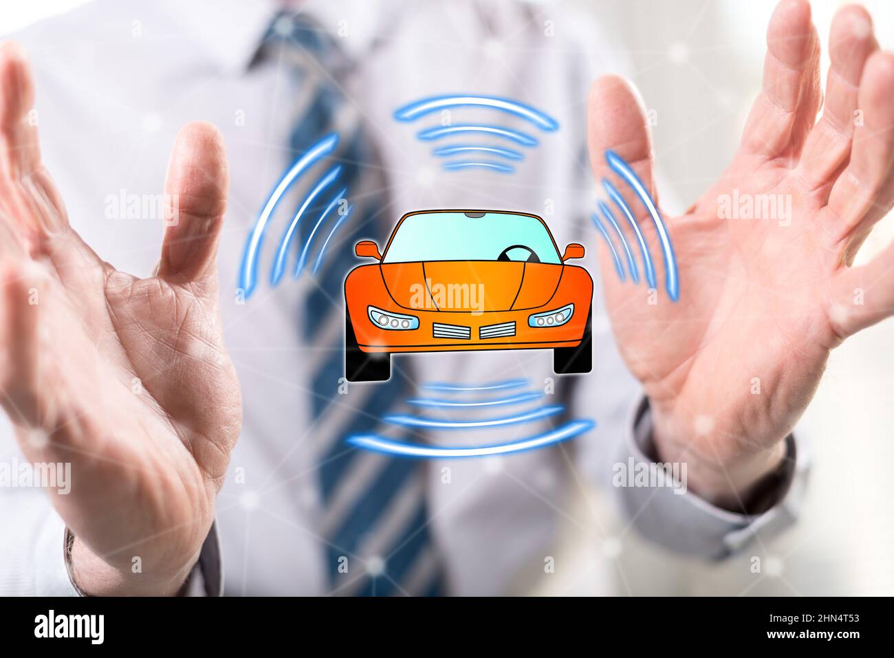 Smart car concept between hands of a man in background Stock Photo - Alamy