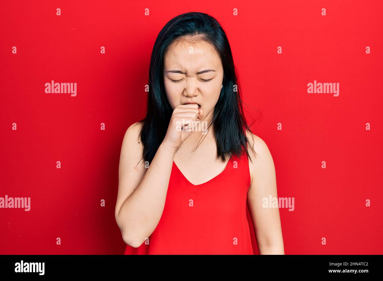 Young Chinese Girl Wearing Casual Clothes Feeling Unwell And Coughing
