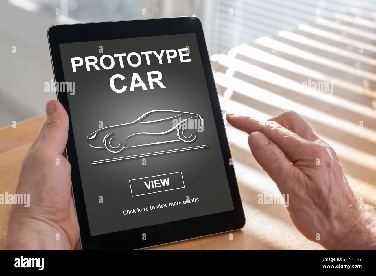 Tablet screen displaying a prototype car concept Stock Photo - Alamy