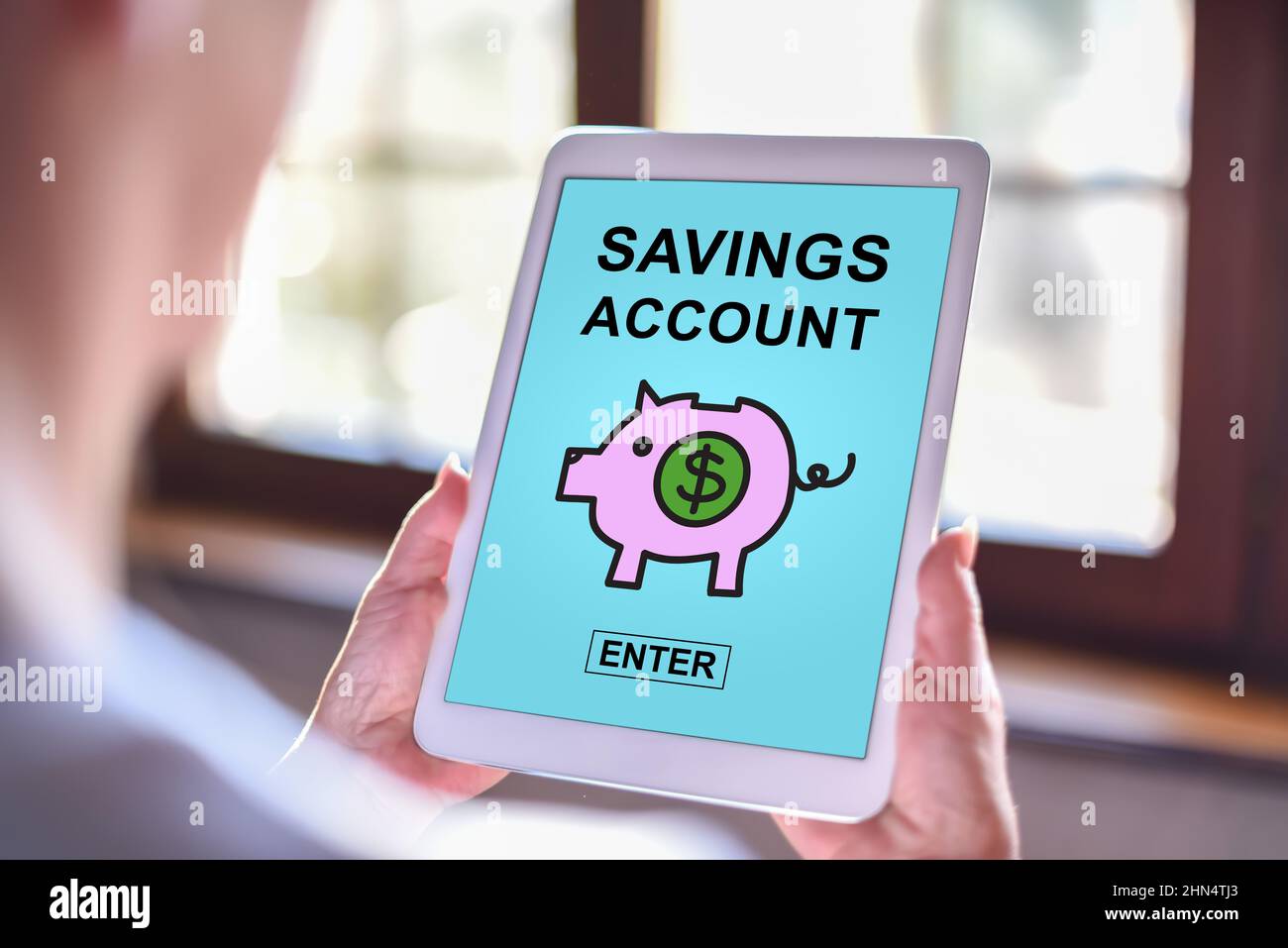 Tablet screen displaying a savings account concept Stock Photo - Alamy