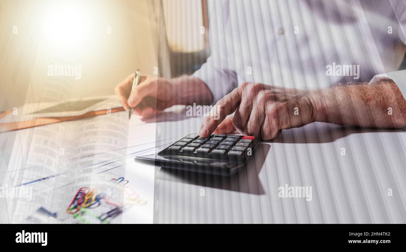 Male hand using calculator, accounting concept, light effect, double ...