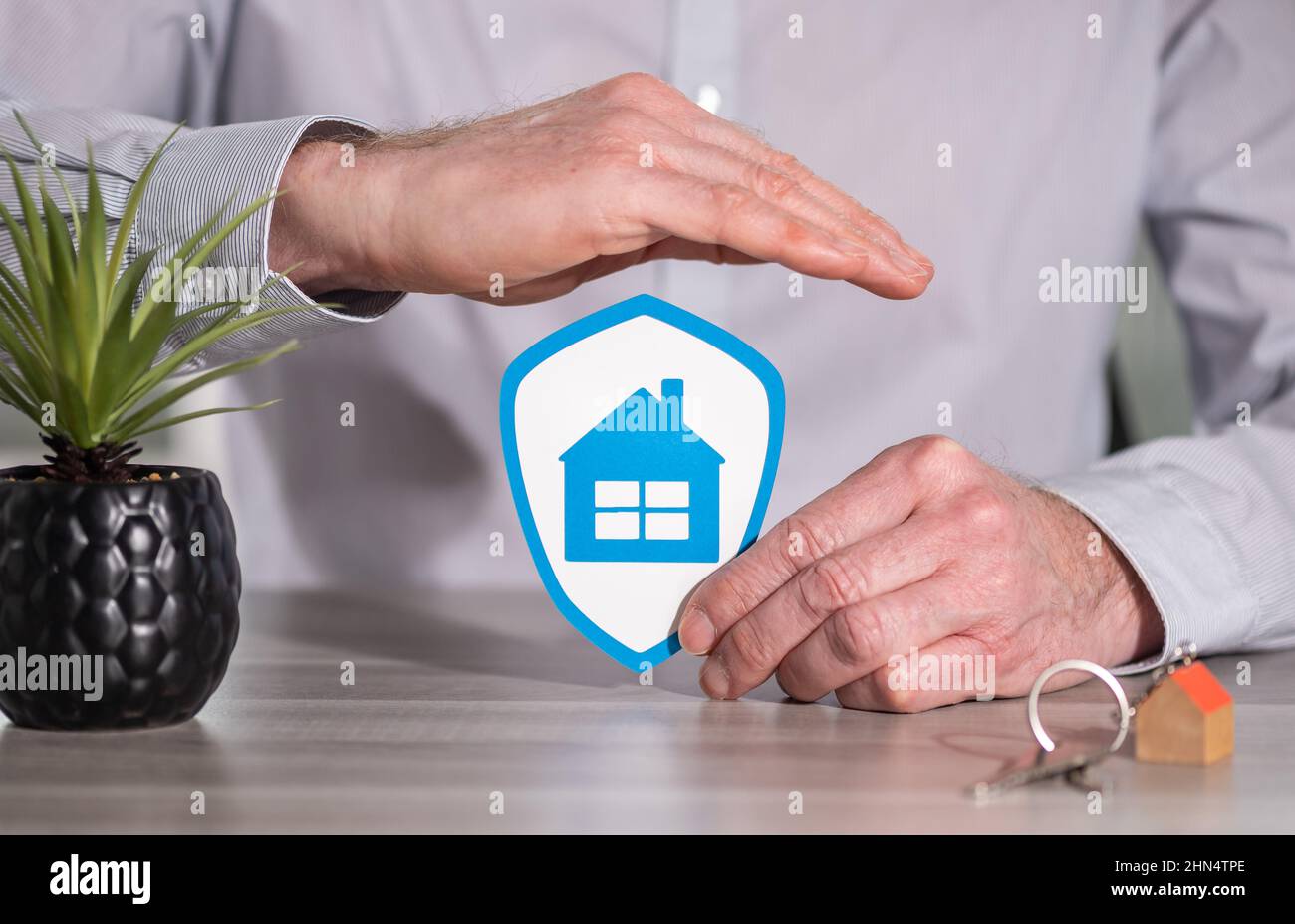 Concept of home insurance with paper shield protected by hand of ...