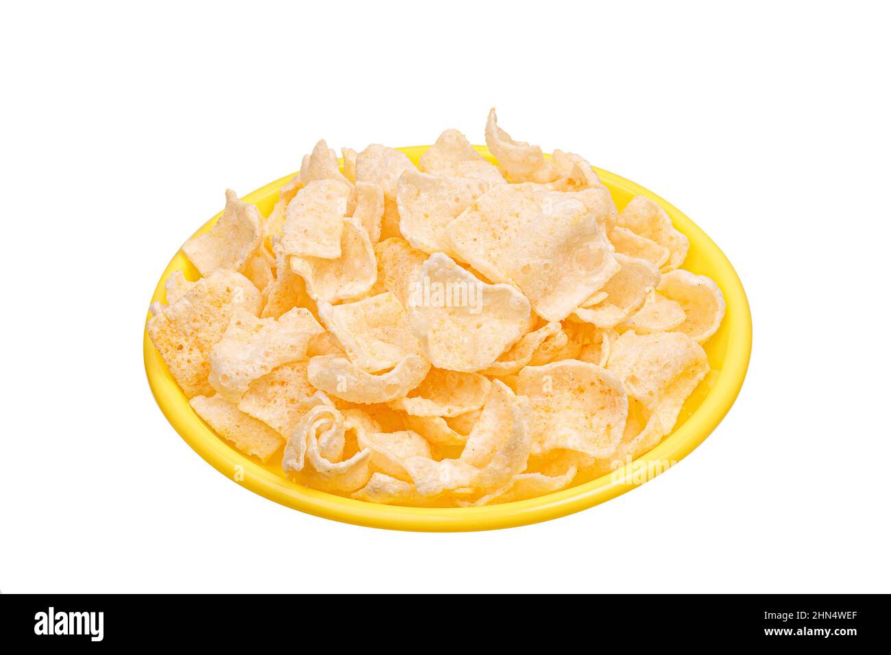 potato chips on yellow plate isolated on white background. side view ...