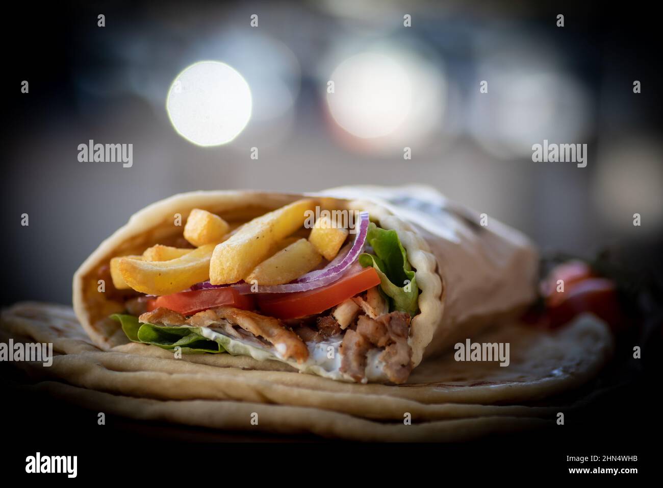 Greek Gyros street food for take away, nicely wrapped with tomato ...