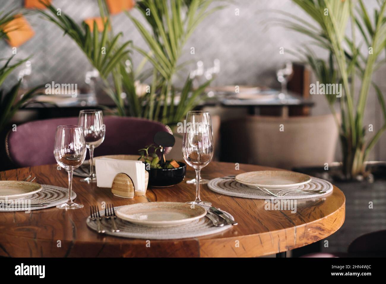 Empty dishes and cutlery on the table in the restaurant before dinner ...