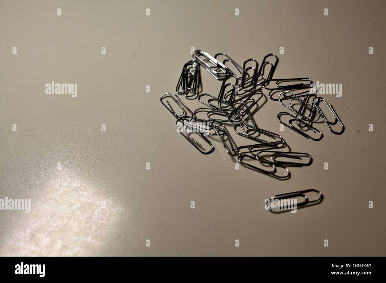 Clips scattered on a desk Stock Photo - Alamy