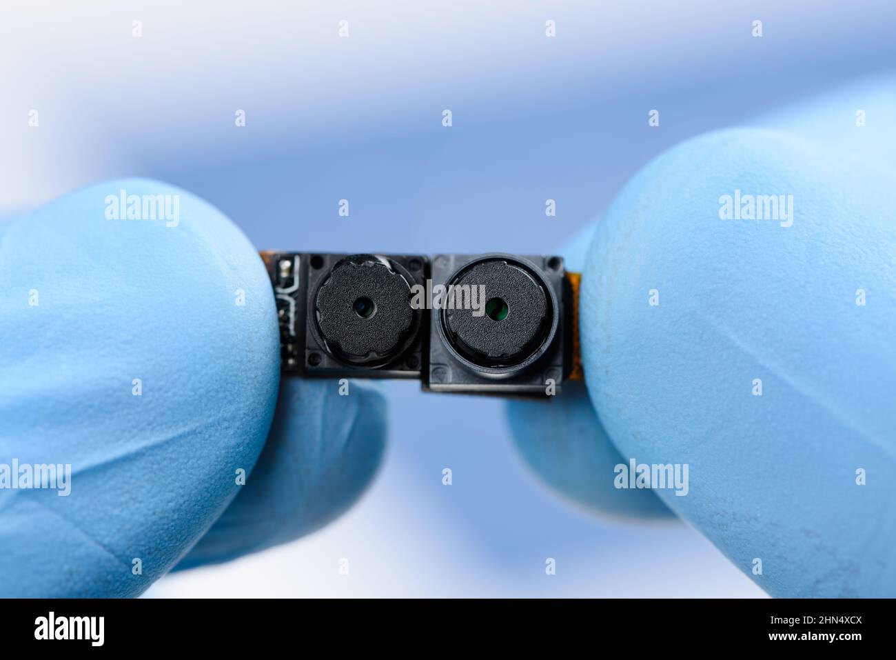 Two camera modules in scientist hands. Smartphone sensor research or ...