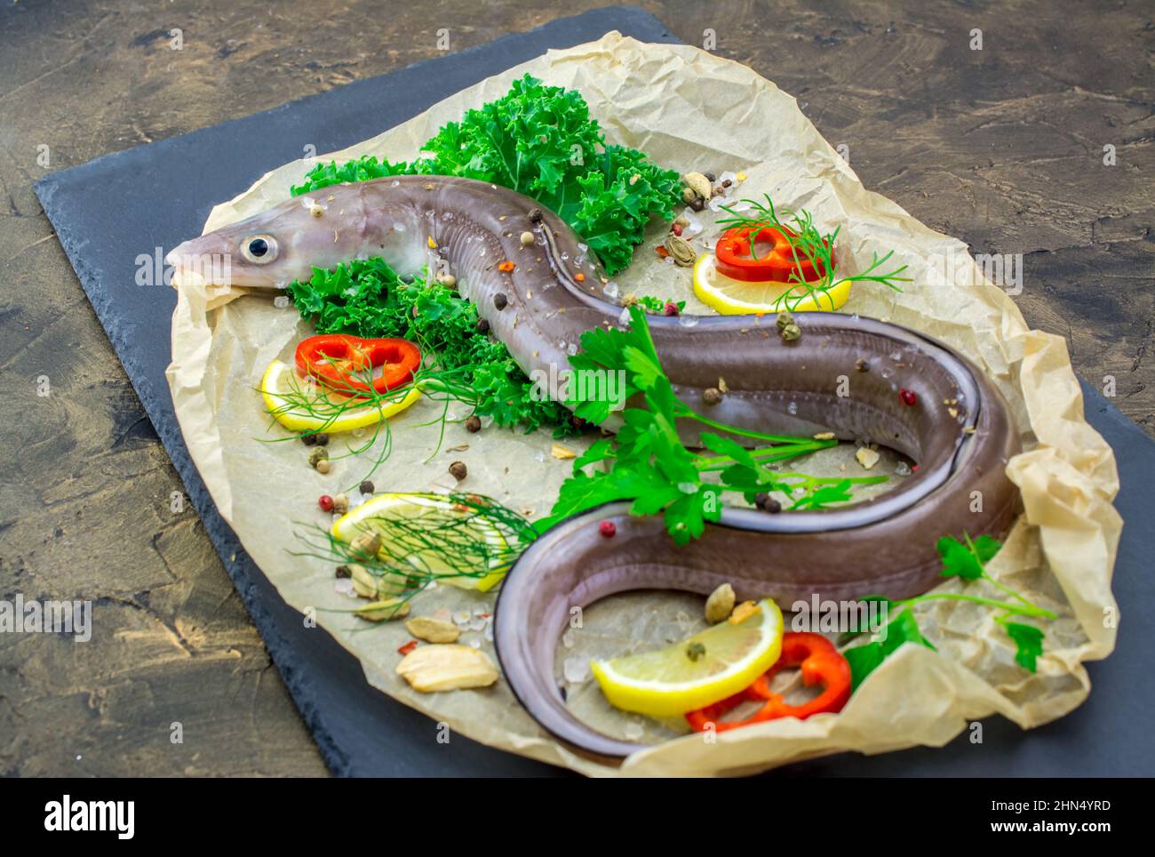uncooked row conger fish with vegetables Stock Photo - Alamy