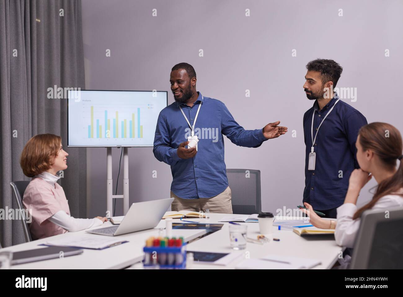 Happy African-American manager or expert introducing new employee to ...