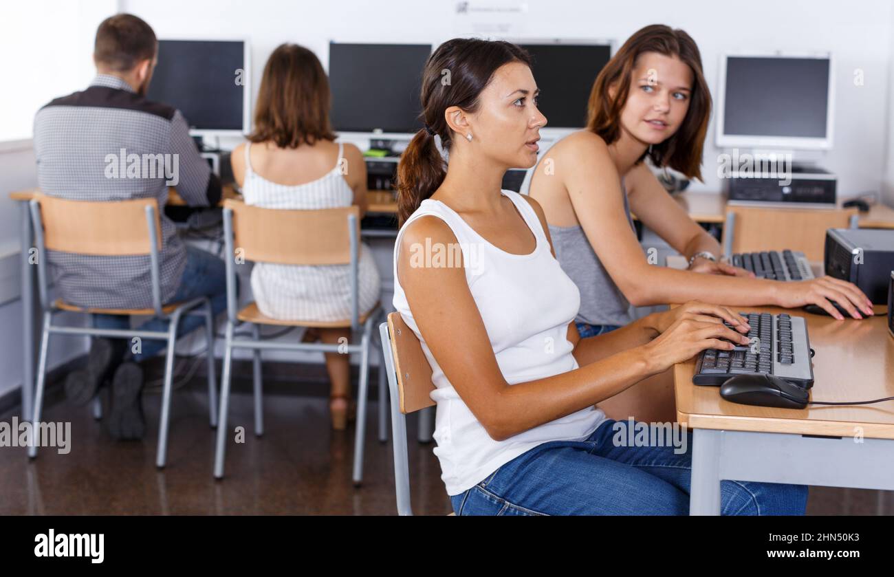 Girls using pc in library Stock Photo - Alamy