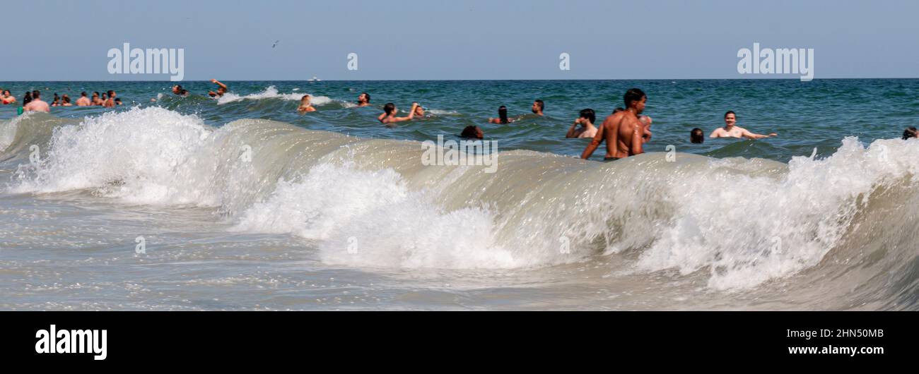 Fire Island, New York, USA - 24 July 2021: People swimming and playing ...