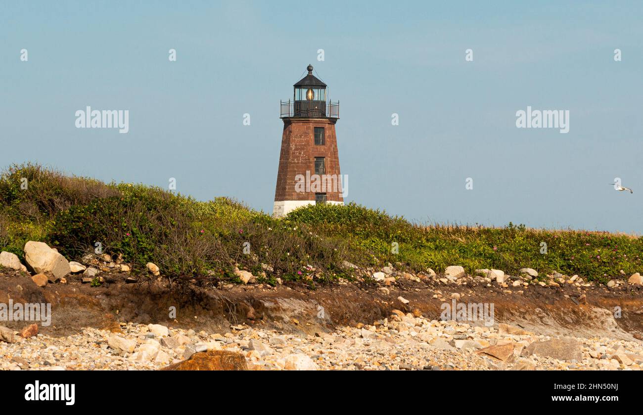 The Point Judith Lighthouse above sand dunes and beach grass brush in ...