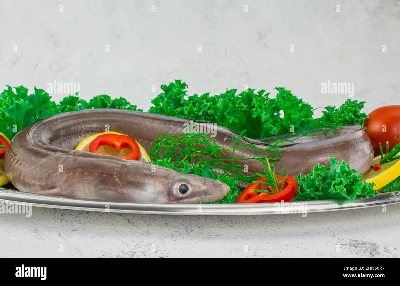 uncooked row conger fish with vegetables Stock Photo - Alamy