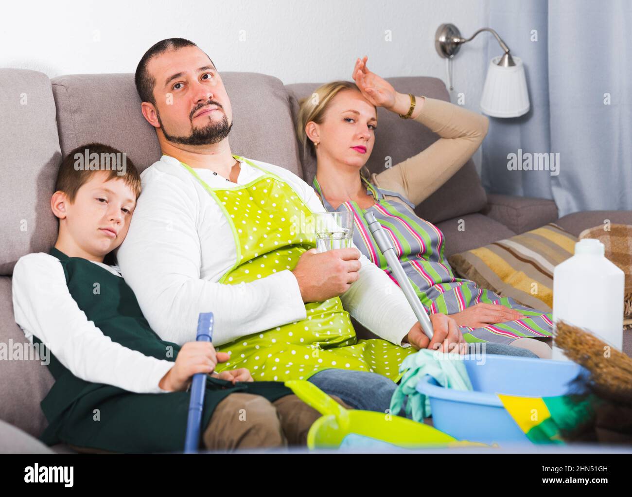 Tired family after home cleaning Stock Photo - Alamy