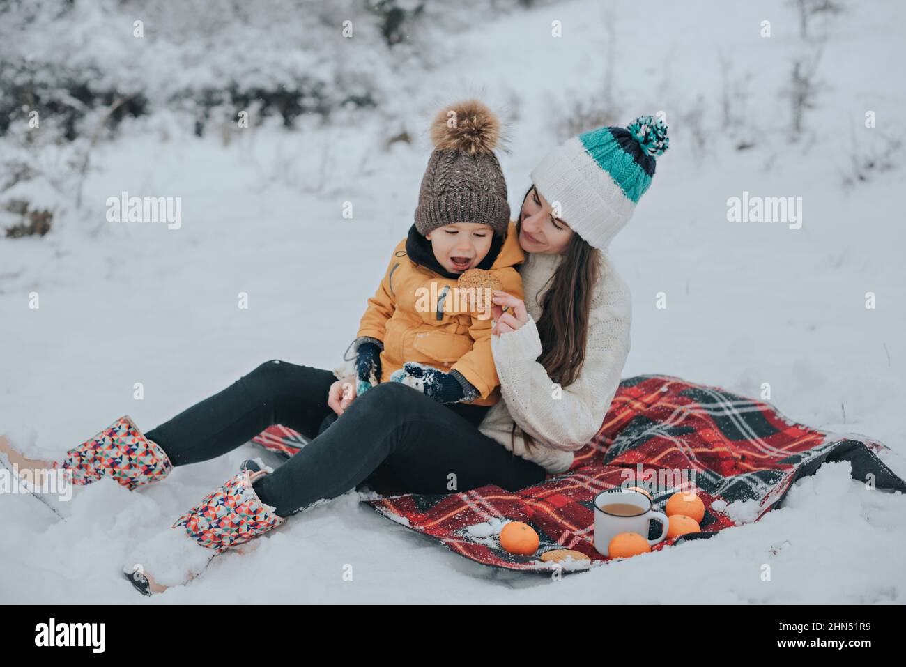 Mother and child on a winter walk outdoors drinking tea Stock Photo - Alamy