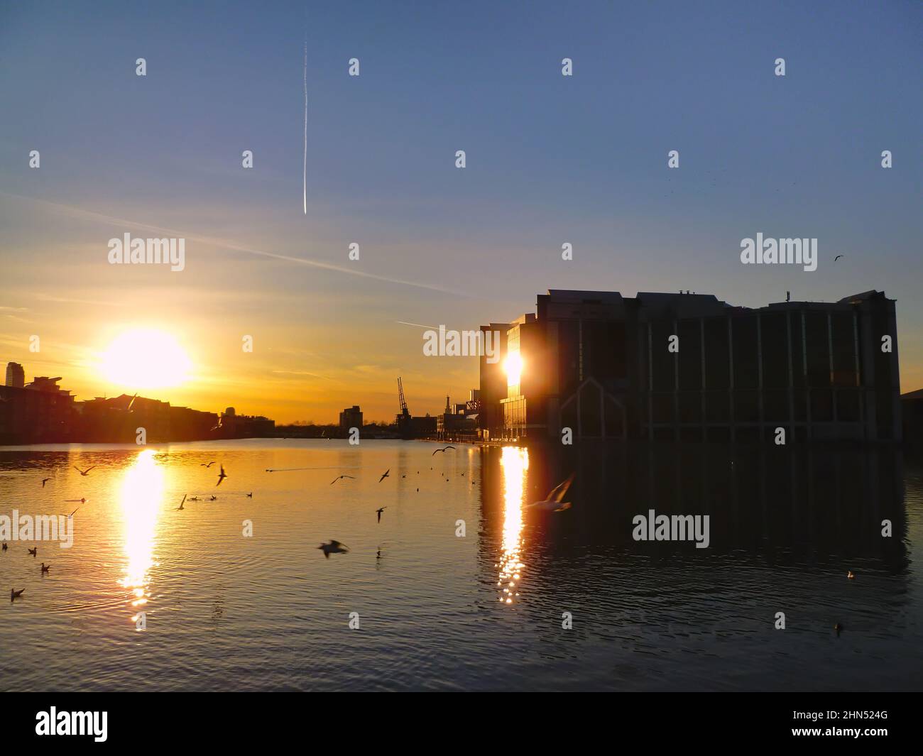 Sunset and yellow horizon over Docklands in London Stock Photo - Alamy