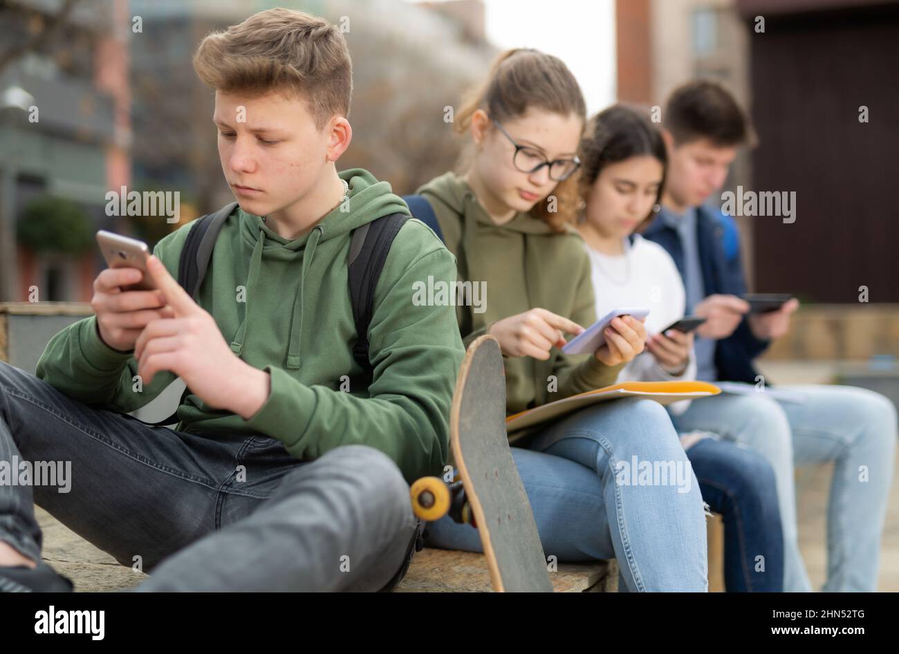 Teenagers chatting on their smartphone on walking Stock Photo - Alamy