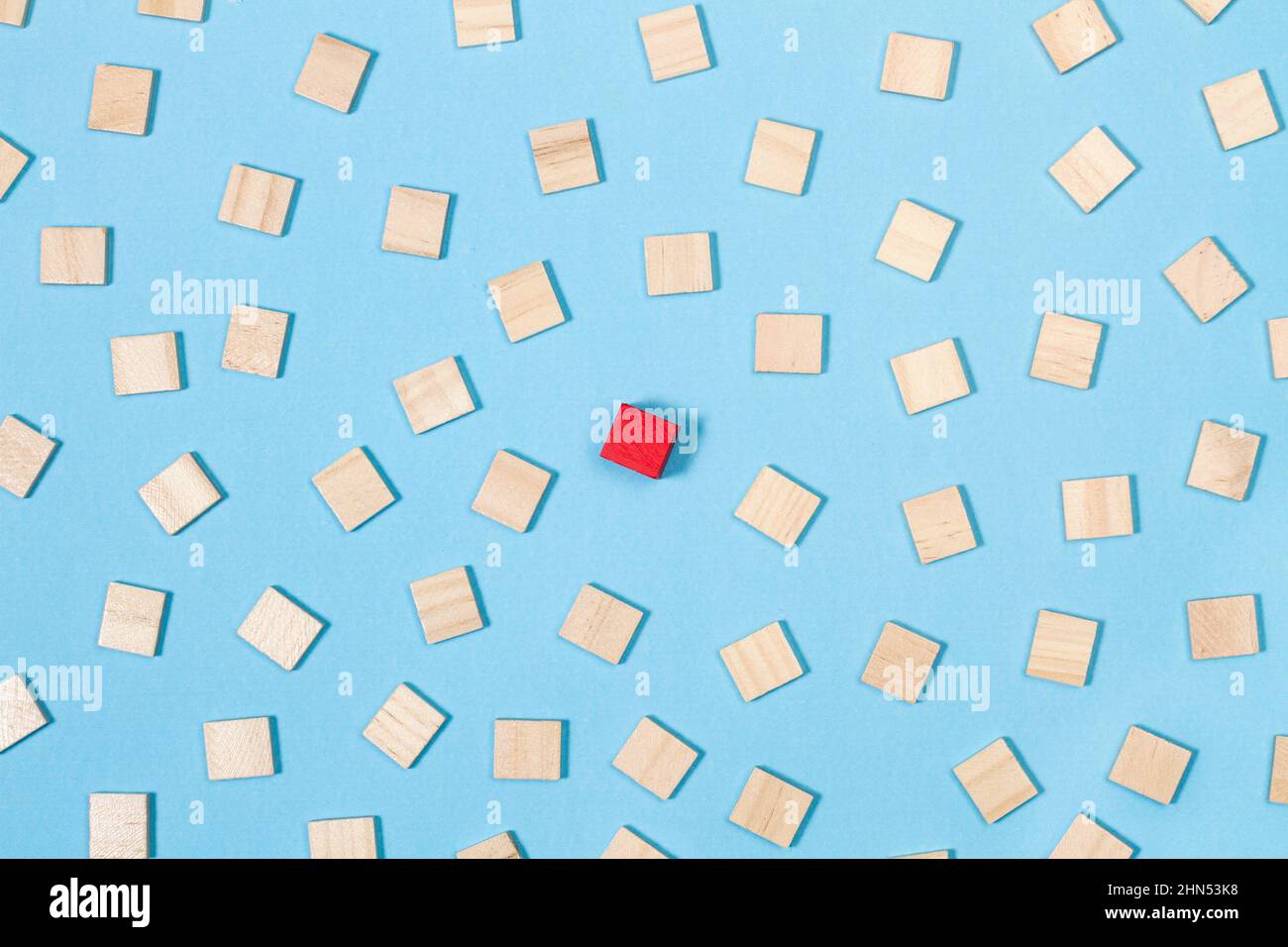 Square wooden blocks and one red block on a light blue background Stock ...