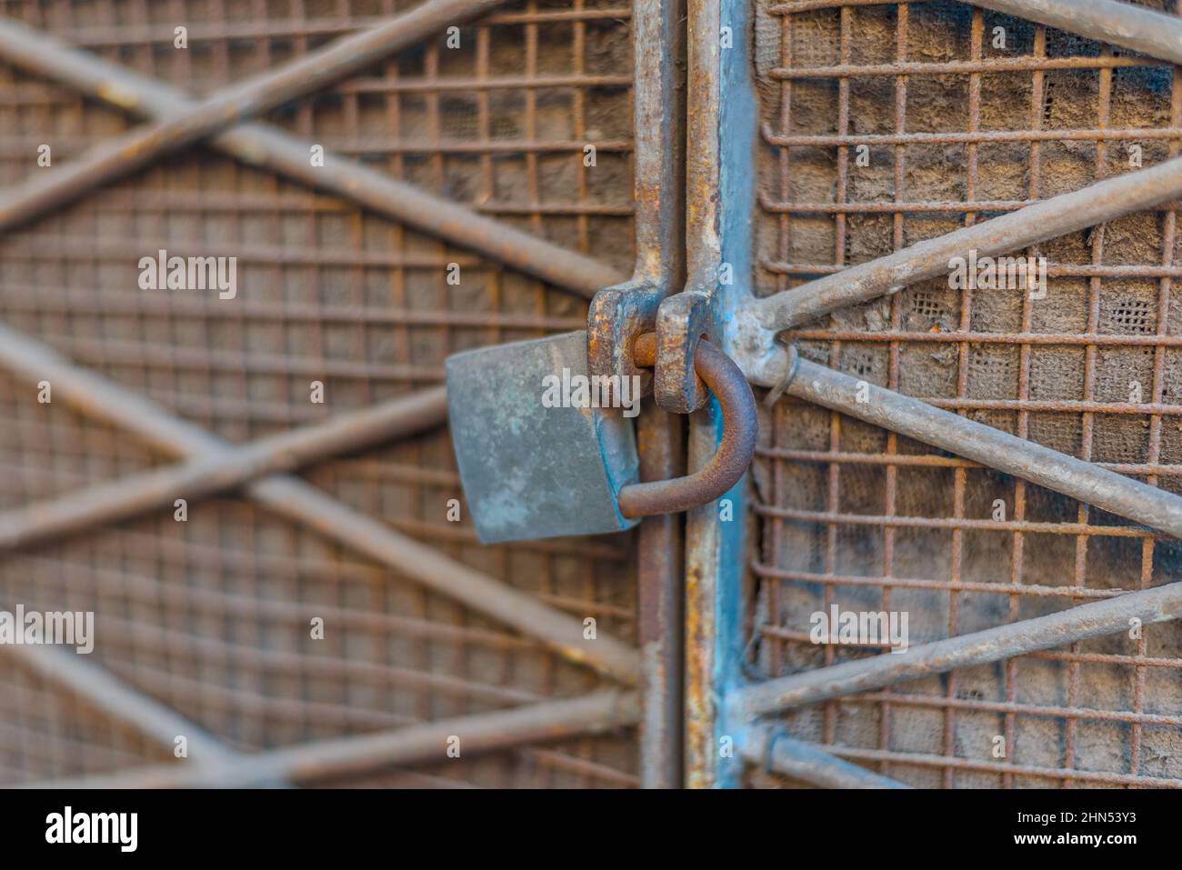 Old padlock window with a rusty iron window frame Stock Photo - Alamy