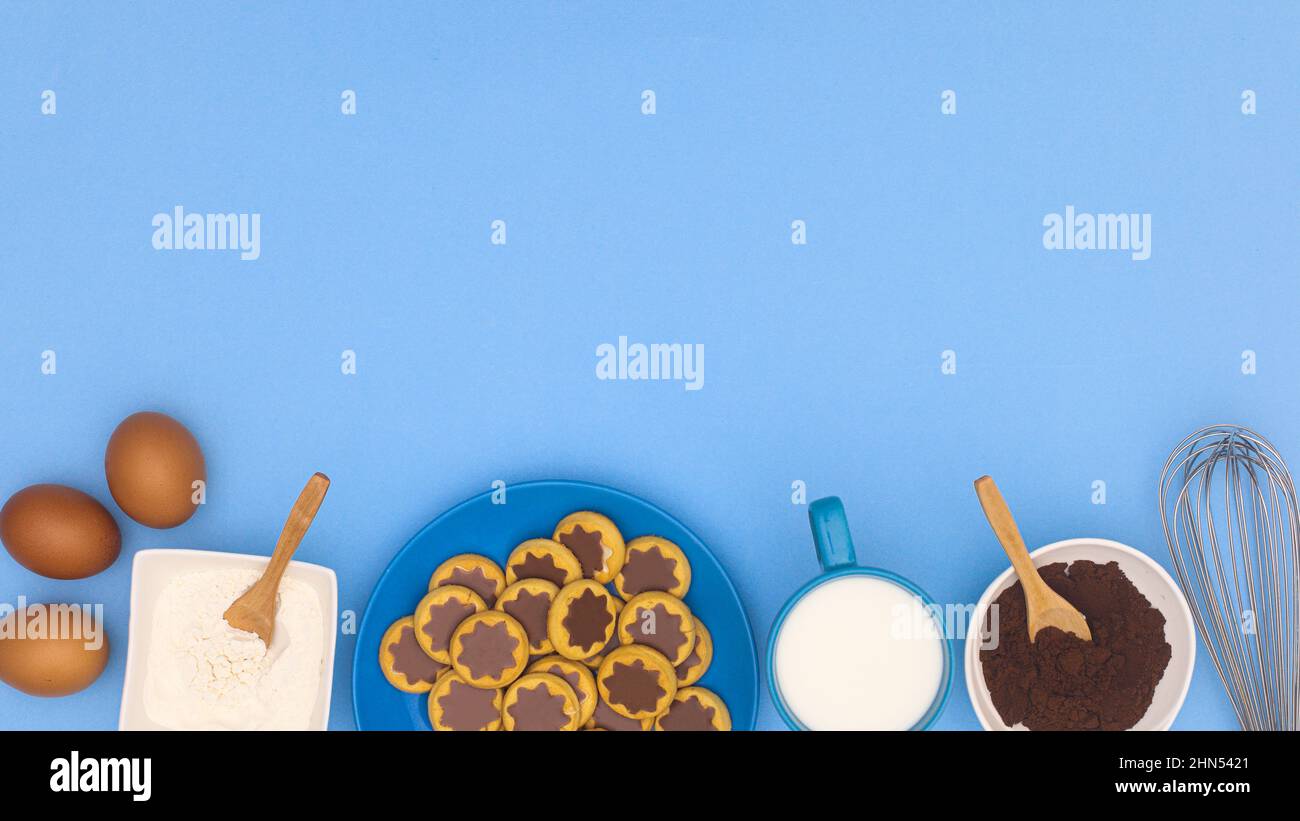 Pastel blue background with ingredients for making cookies and fresh ...