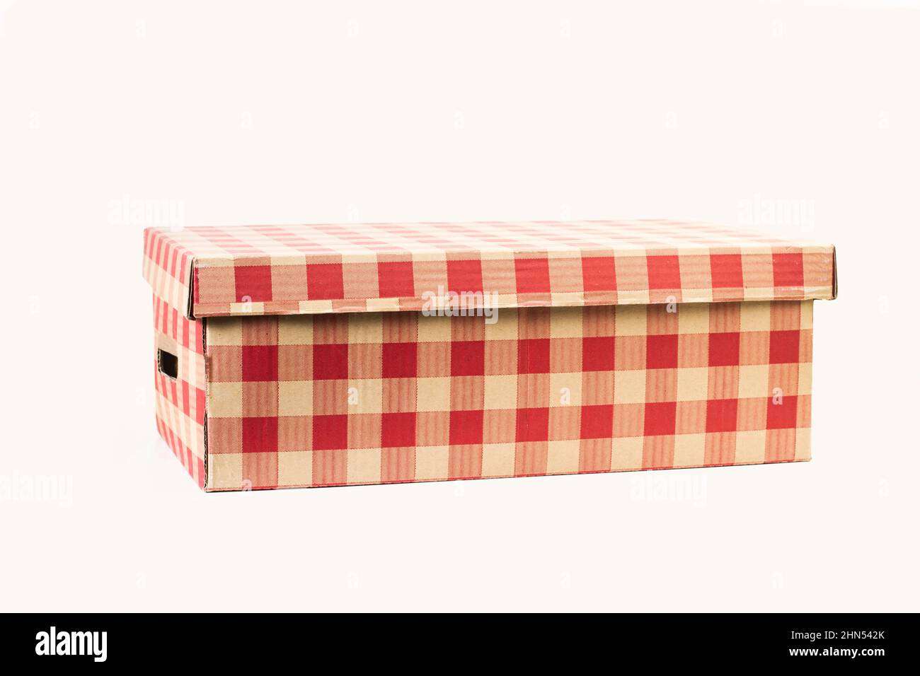 A closed red and yellow chequered box on a white background Stock Photo ...