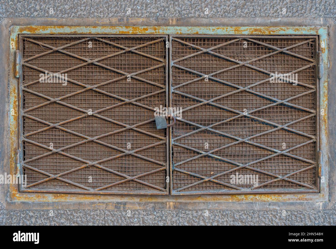 Old window with a rusty iron window frame and padlock Stock Photo - Alamy