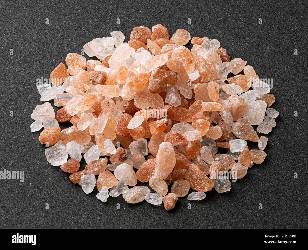 Pile of pink himalayan salt on black background Stock Photo - Alamy
