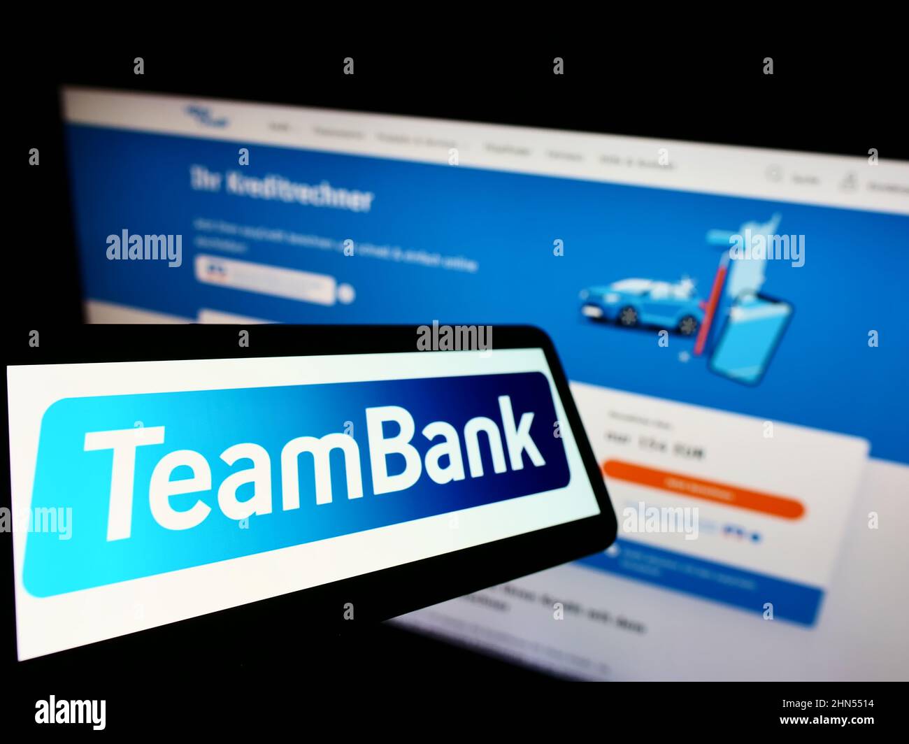 Smartphone with logo of German company TeamBank AG Nurnberg on screen ...