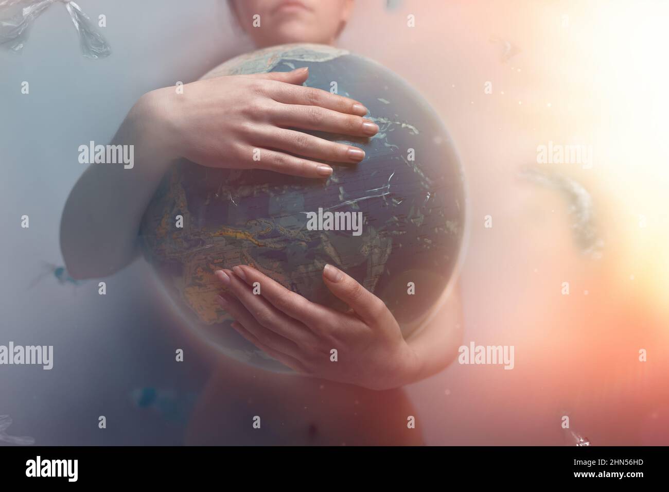 Woman embracing the globe of planet Earth. The concept of preserving ...