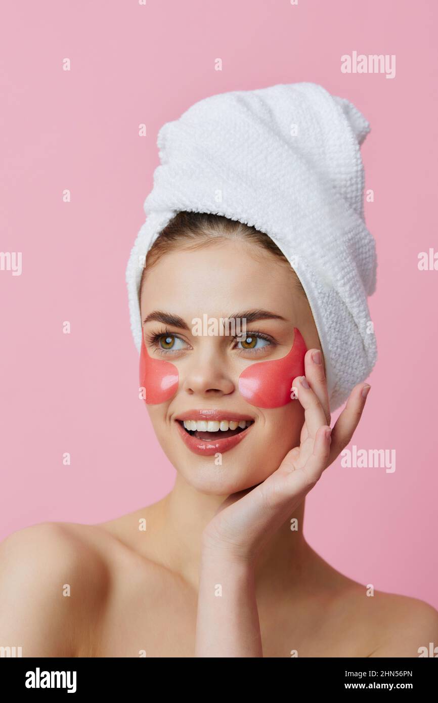pretty woman pink patches on the face with a towel on the head pink ...