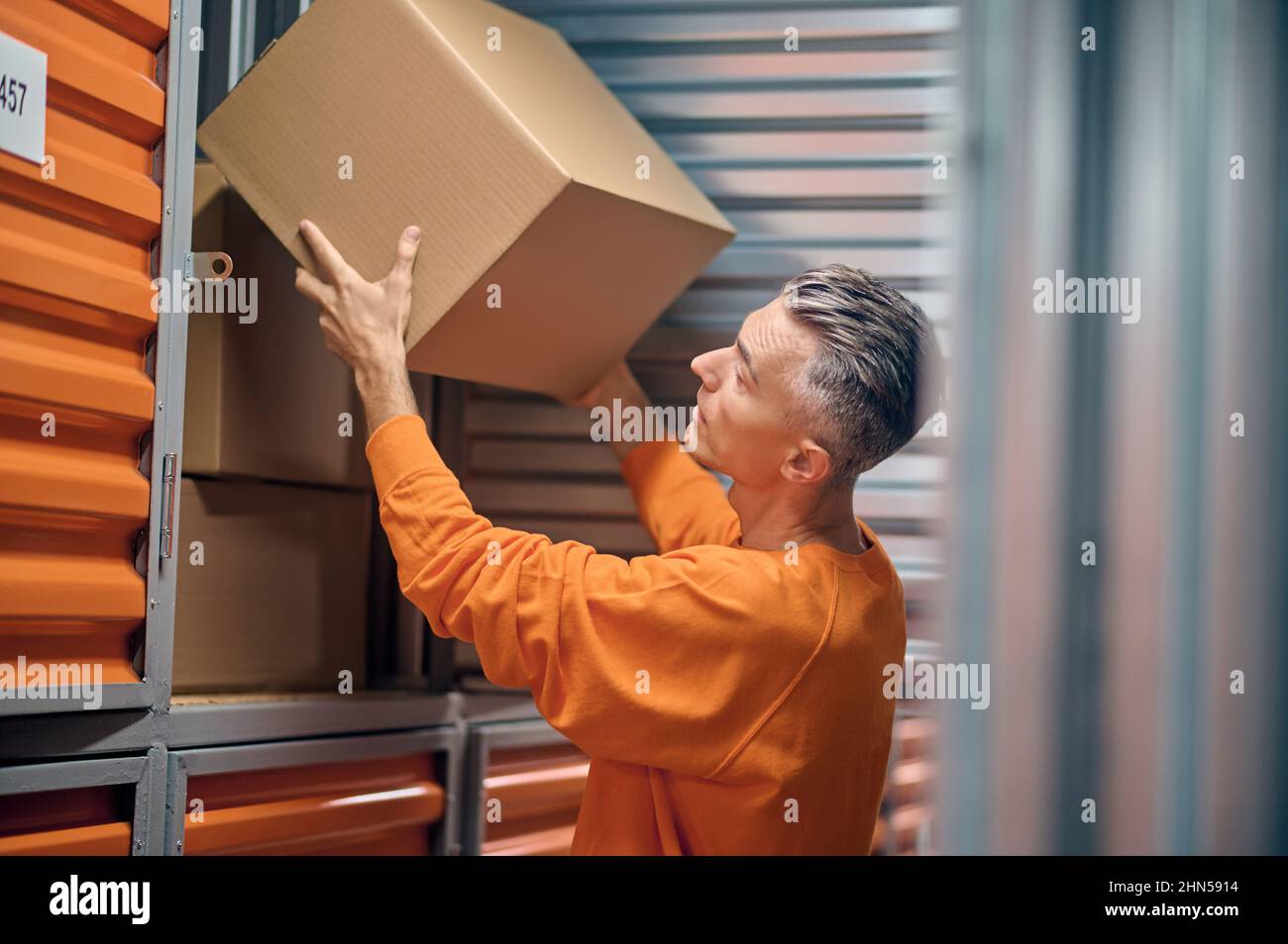 Order picker choosing ordered items for delivery Stock Photo - Alamy