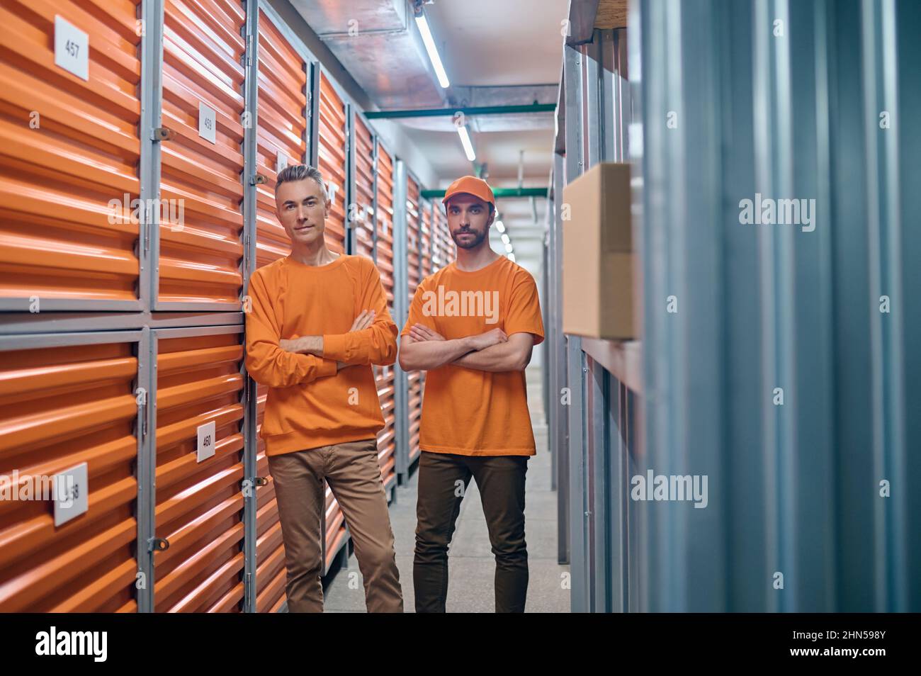 Two storehouse employees posing for the camera in the workplace Stock ...