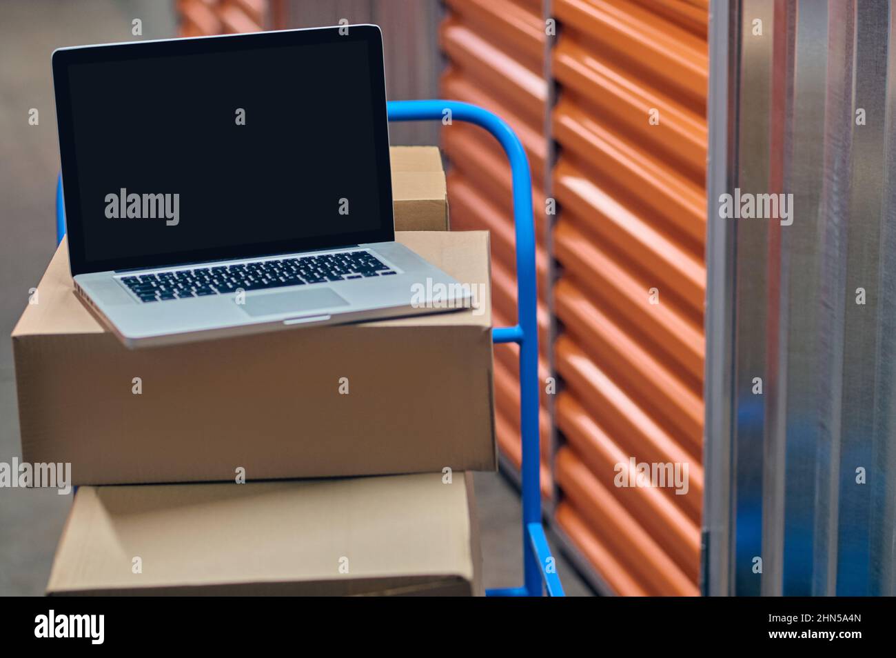 Unboxed new laptop positioned on packaged wares Stock Photo - Alamy