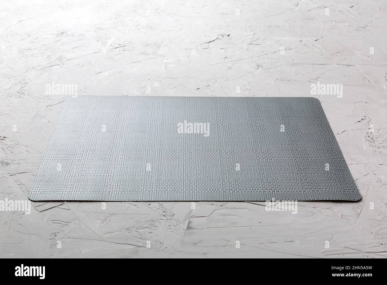 Perspective view of grey tablecloth for food on cement background ...